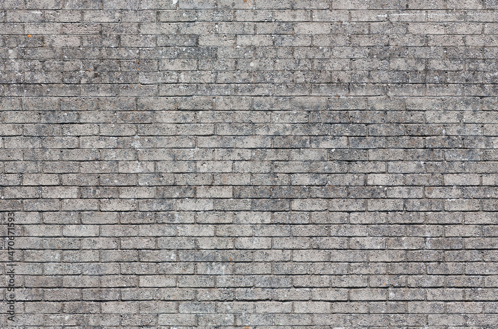 Repeating gray brick wall texture typically found in developed areas ...