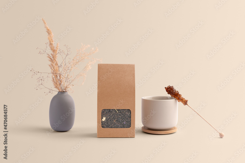 Blank tea packaging with a transparent window, teacup, dried plants ...