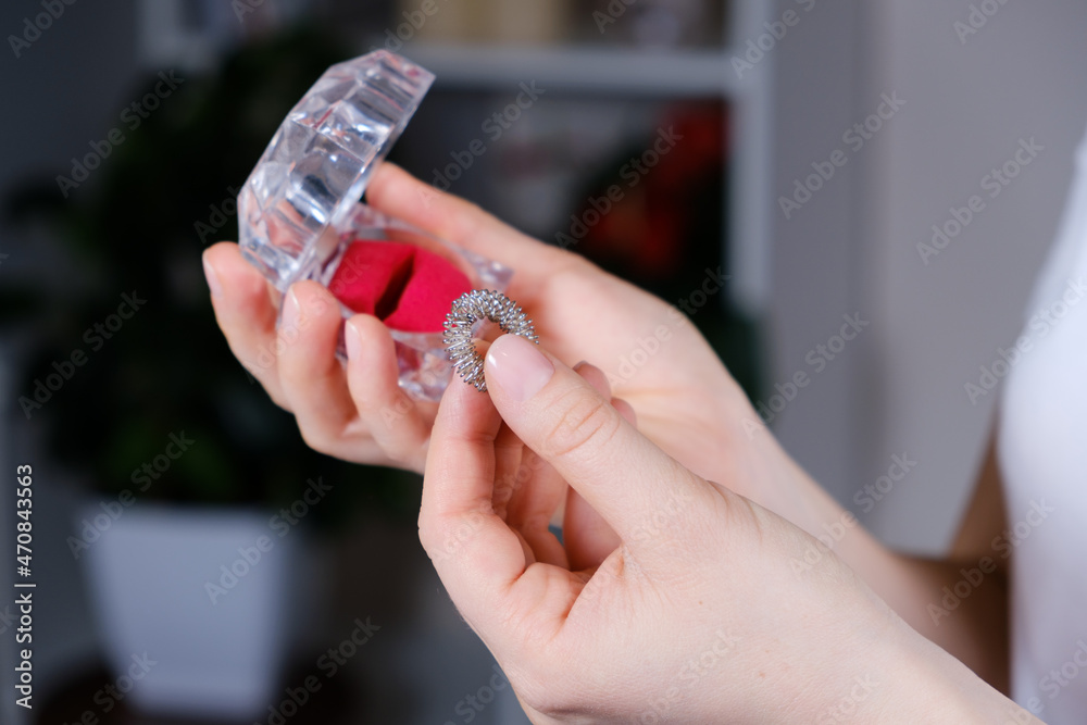 Massage ring for fingers in female hands close-up. Su Jok therapy ...
