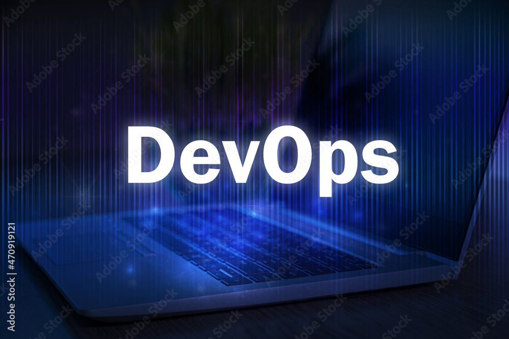 DevOps text on blue technology background with laptop. DevOps combines ...