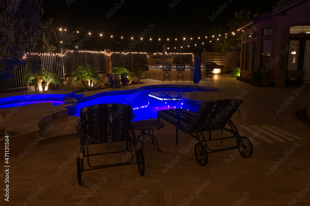 A high definition night time view of a desert landscaped backyard in ...