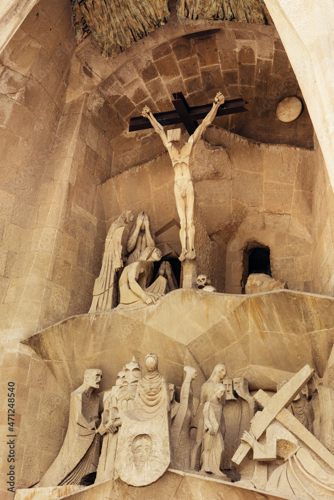 Facade with Christ crucified scene on cathedral La Sagrada Familia designed by Antonio Gaudi ...