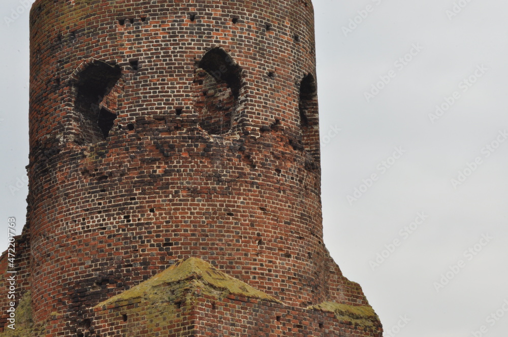Castle ruins in Koło. Destroyed towers and defensive walls made of red ...