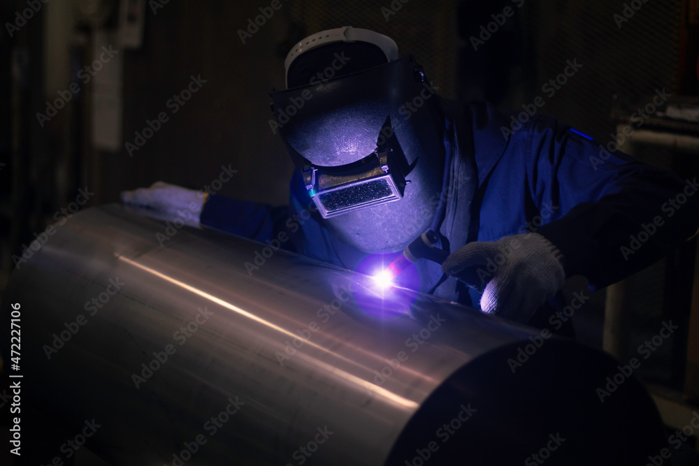Welder is welding the steel in the factory. Weld the steel in dark ...