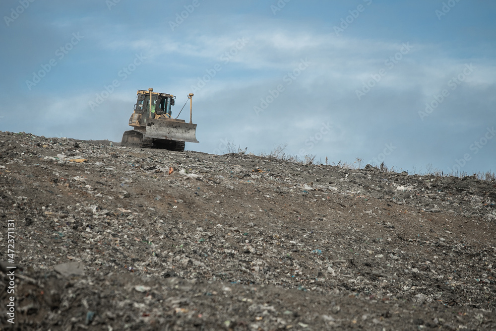 Recycling concrete and construction waste from demolition. Excavator at ...