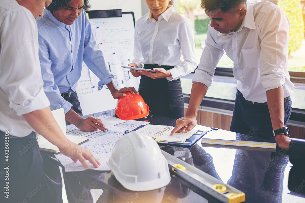 contractor and engineer with blueprints discuss at a modern ...