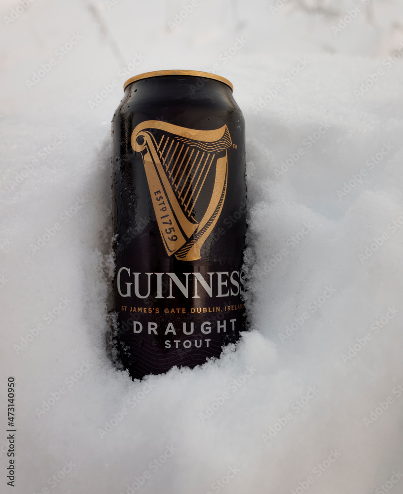Can of Guinness draught Irish beer in snow, winter. Guinness is a ...