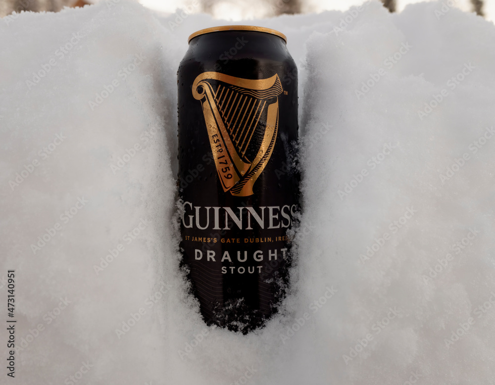 Can of Guinness draught Irish beer in snow, winter. Guinness is a ...