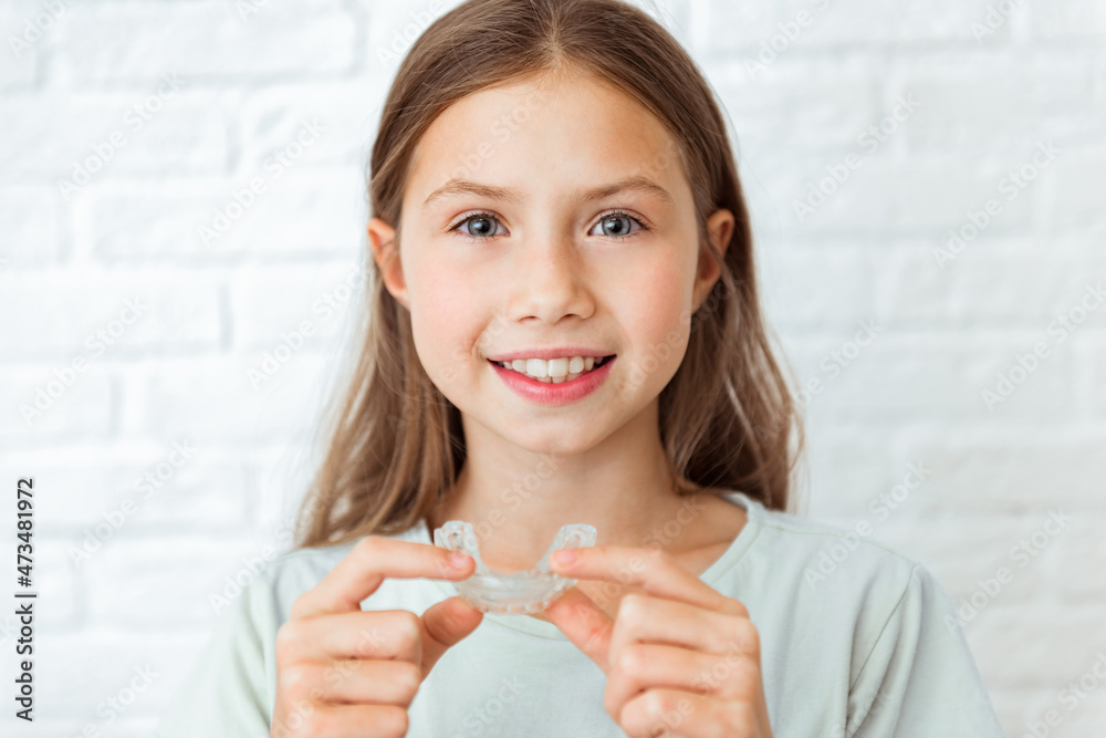 Smiling child girl with perfect and healthy teeth using removable ...