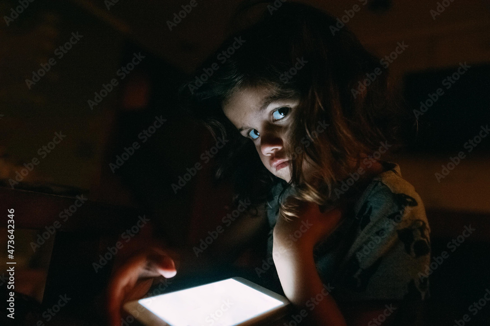 Child giving side-eye view at camera. Stock Photo | Adobe Stock