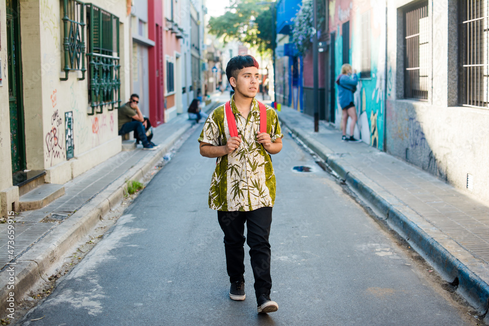 Latino gen z walking down the street Stock Photo | Adobe Stock
