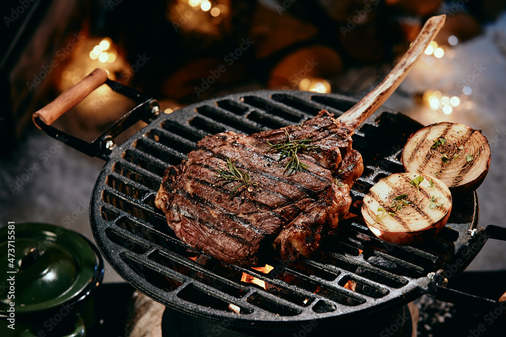 Tomahawk steak cooking on grill rack Stock Photo | Adobe Stock