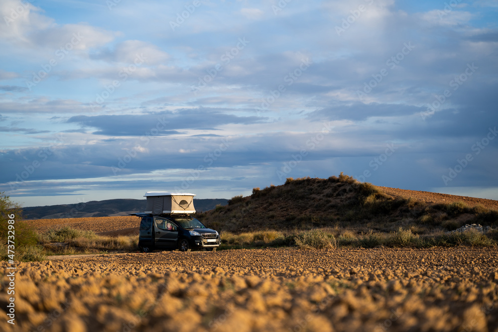 Camper van parked in the middle of desert Stock Photo | Adobe Stock