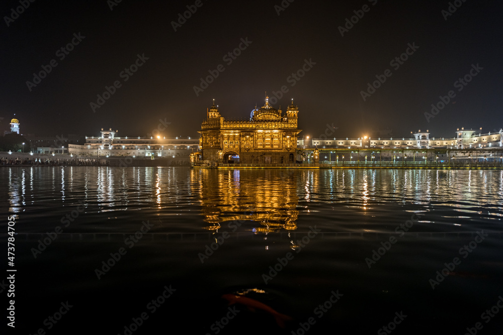 Exterior facade of the Golden Temple of Amritsar illuminated at night ...