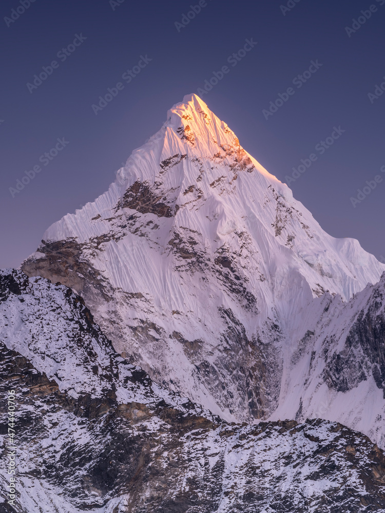 Triangle snow peak in last sun light under dark blue sky in Nepal Stock ...