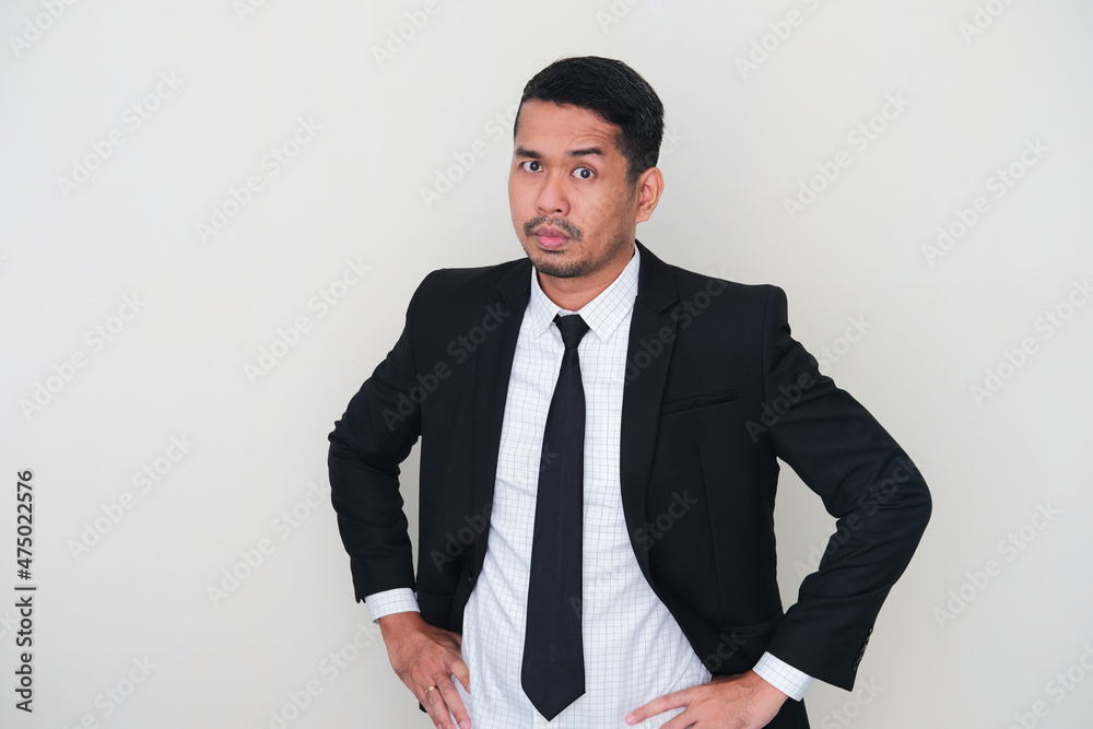 Adult Asian man wearing black suit and tie showing fierce face with his ...