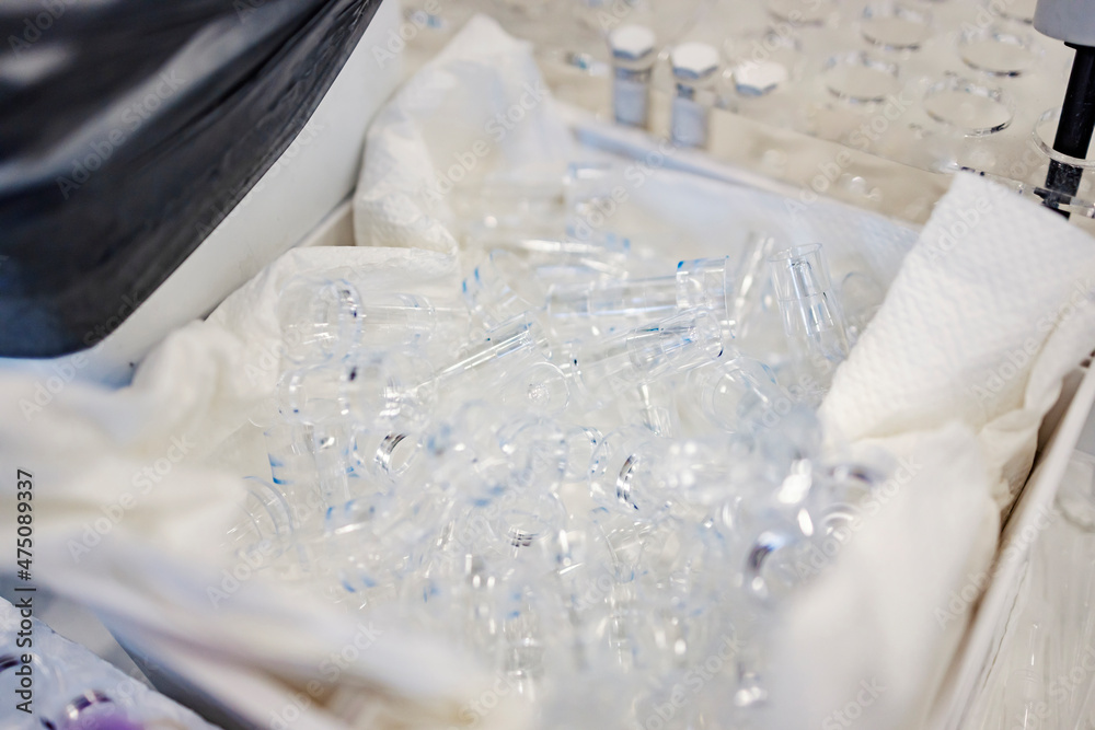 Medical waste in a bin. Close up of the used test tubes in the ...