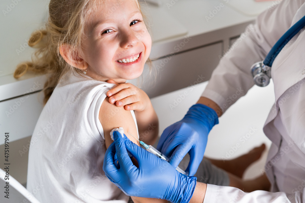 vaccination of children, a little girl at a doctor's appointment, an ...