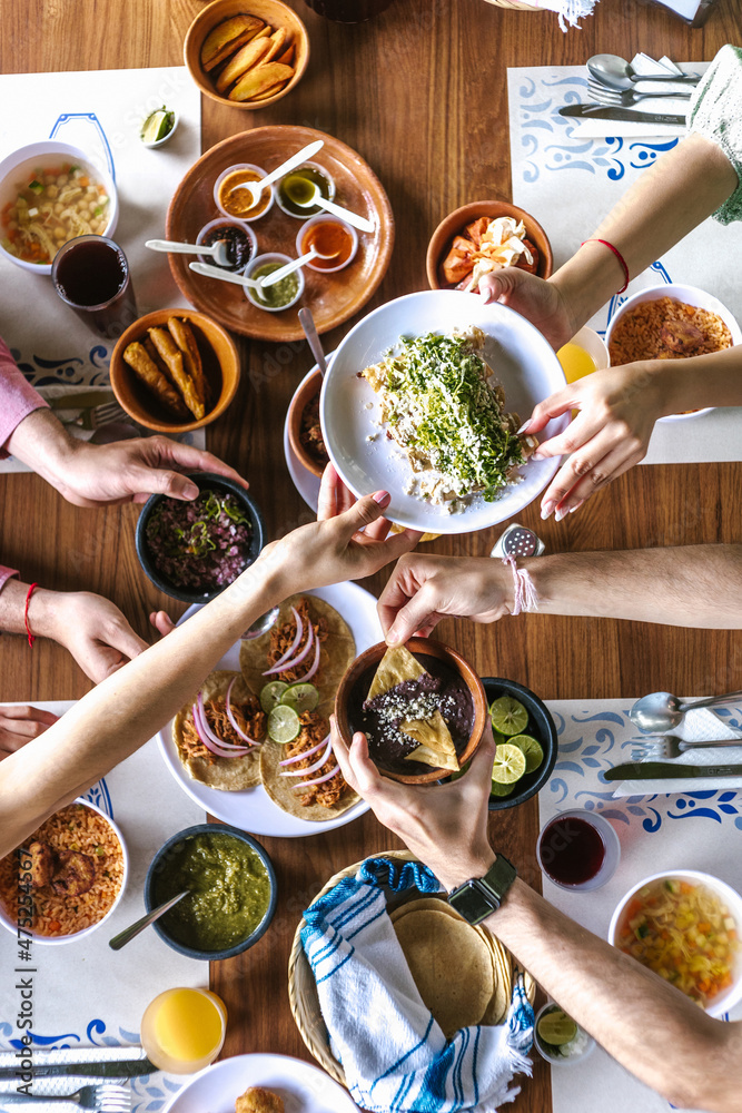 Group of friend eating mexican tacos and traditional food, snacks and ...