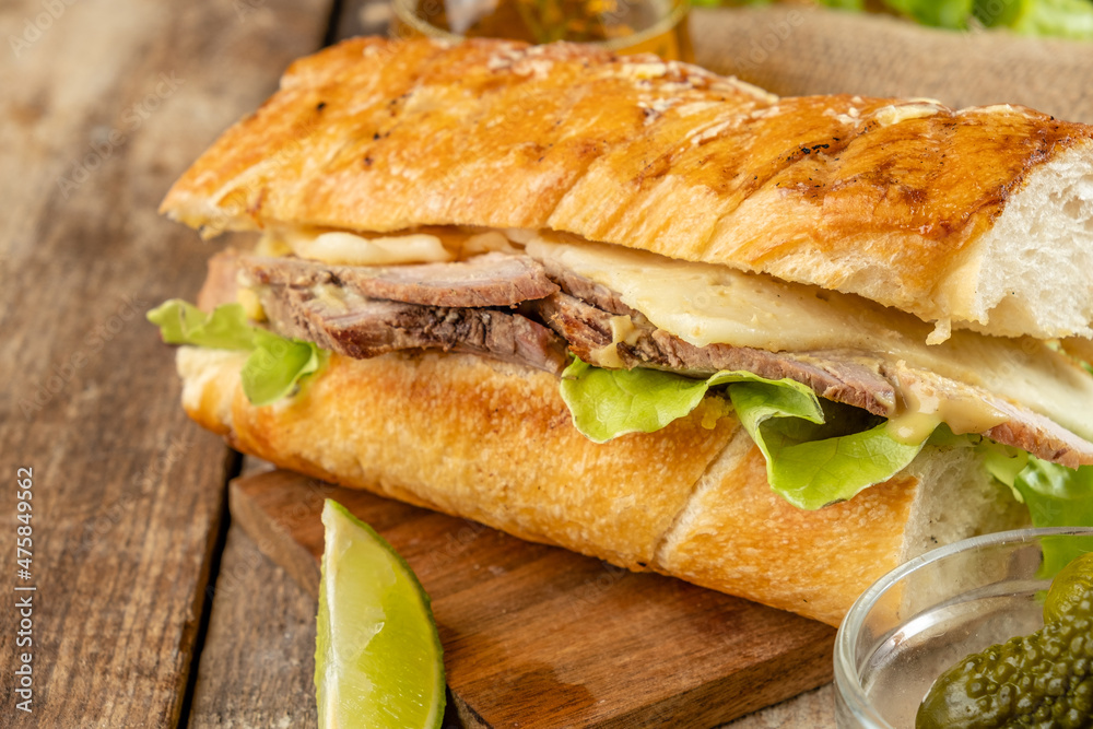 Sandwich cubano with pork and vegetables with mustard sauce in a ...