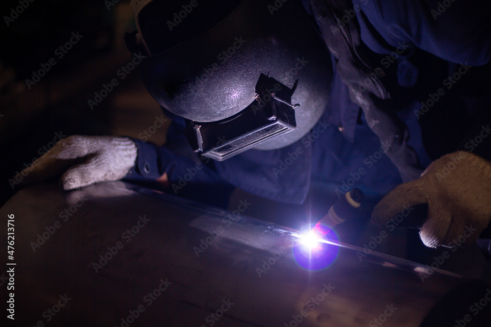 builder wear fireproof gloves for safety at work. working on high ...