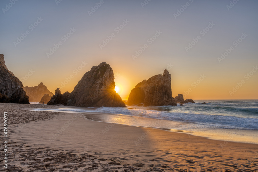 Beautiful sunset on a beach with sea stacks at the portuguese atlantic ...