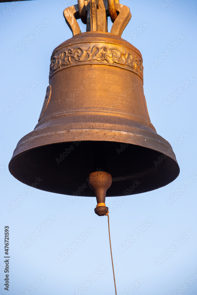 Large Church bell hanging outside. Close-up view of metal orthodox ...