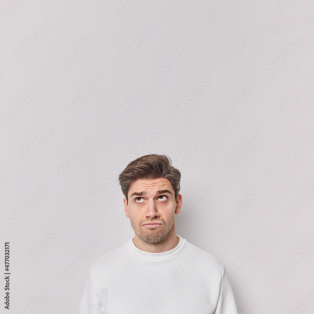 Fotografie Displeased young brunet man has sulking thoughtful ...