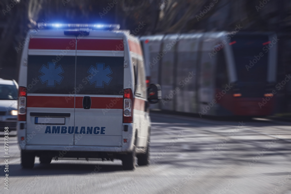Paramedic 911 ambulance car running fast through the big city. Stock ...