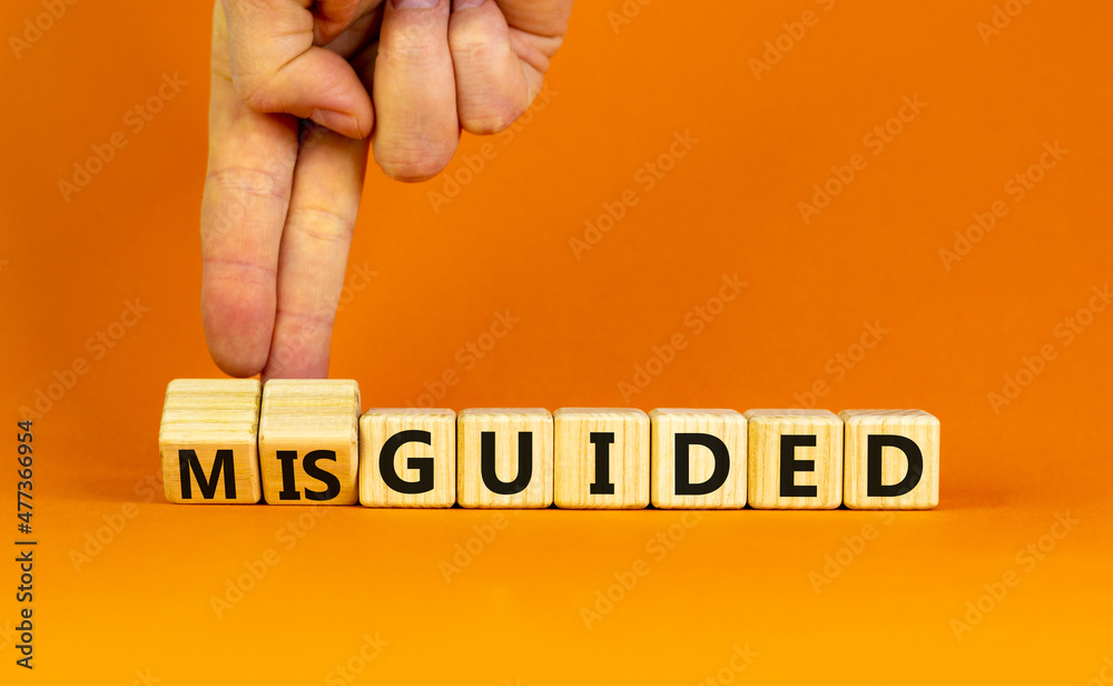 Guided or misguided symbol. Businessman turns wooden cubes and changes ...