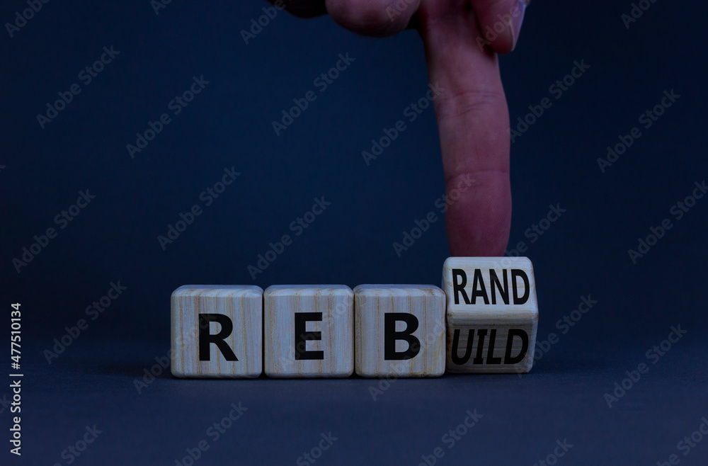 Rebrand and rebuild symbol. Businessman turnsa wooden cubes and changes ...