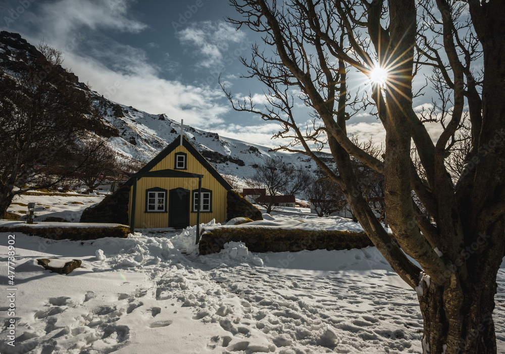 Hofskirkja Church, Hof, Iceland in winter with snow and blue sky. This ...