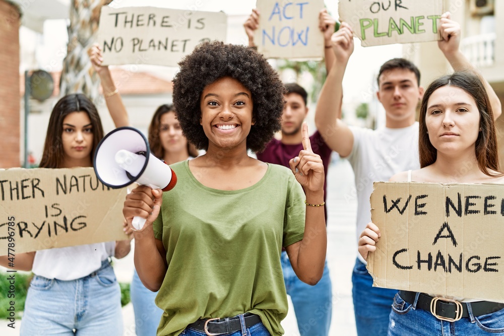Group of young friends protesting and giving slogans at the street ...