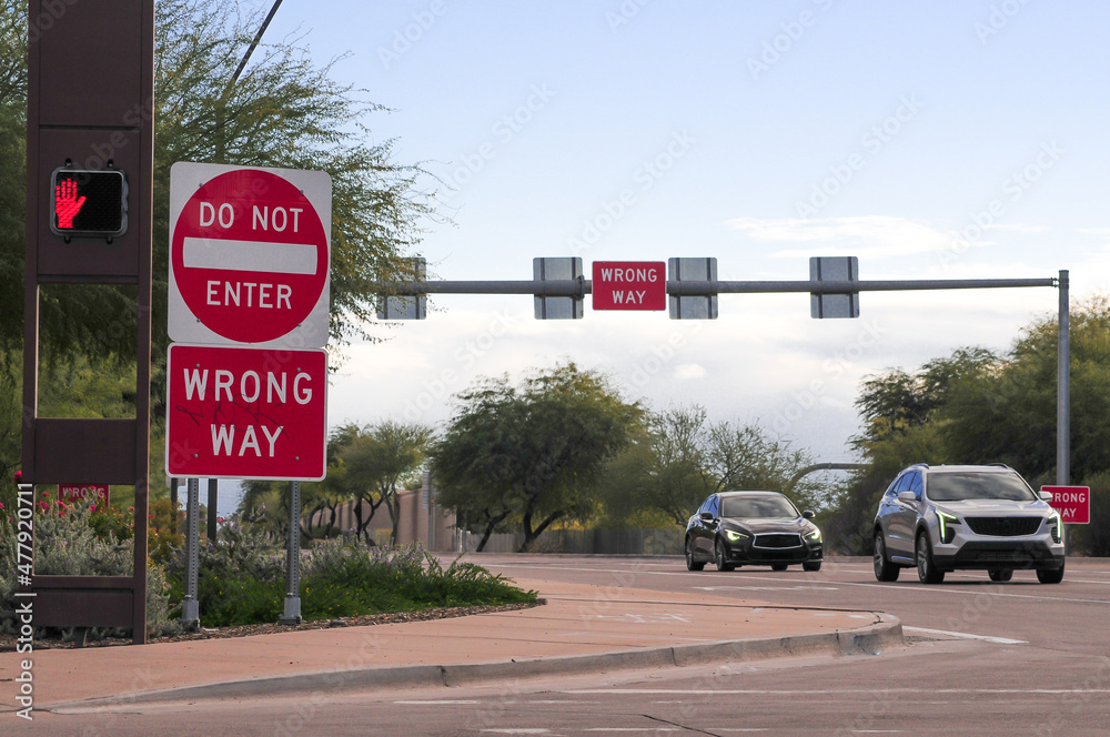 "Do Not Enter" and "Wrong Way" traffic signs located next to a freeway ...