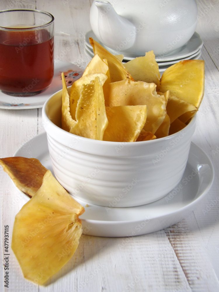 Keripik sukun is chips which made of deep fried thin slice breadfruit. Crispy savory snack ...