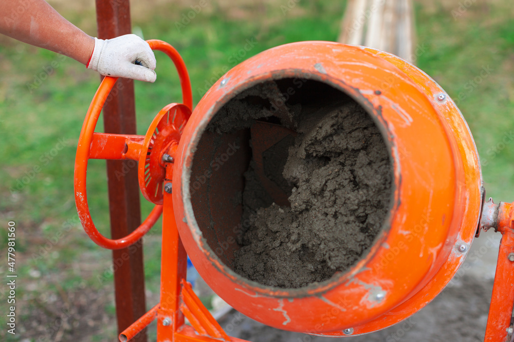 Cement slurry in an orange concrete mixer on a sunny summer day Stock ...