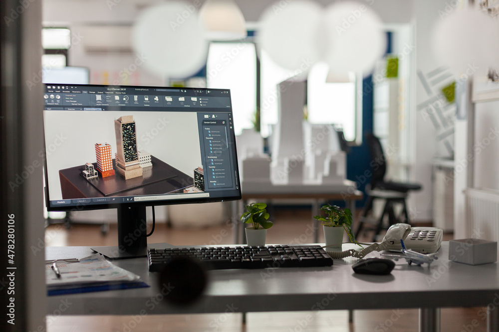 Closeup of modern architect desk with workstation showing 3d blueprints ...