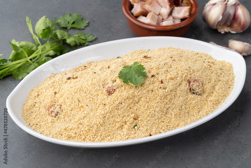 Farofa, typical brazilian manioc flour side dish with seasonings over ...