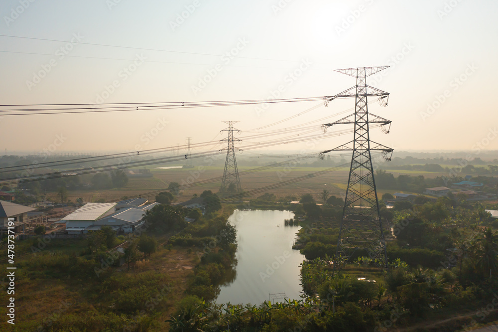 High voltage poles with nature landscape. Power lines on utility tower ...