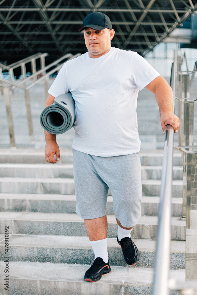 Fat man walking down the stairs Stock Photo | Adobe Stock
