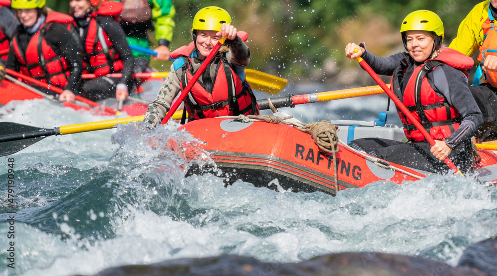 Two girls enjoying themself with river rafting water sports. Smiles ...