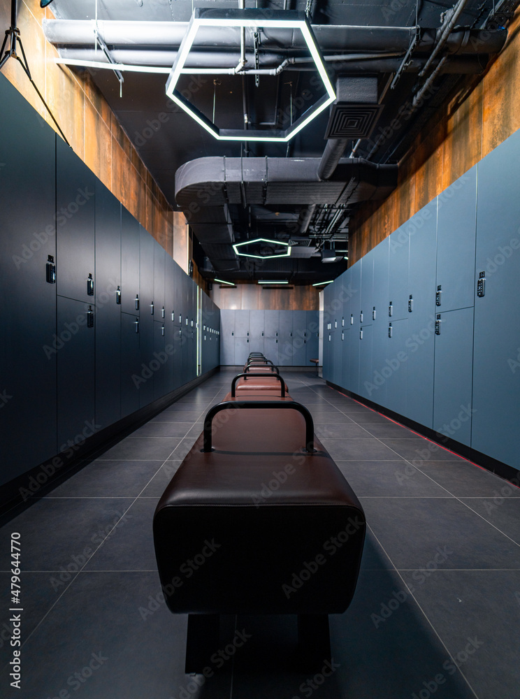 Dark lockers in a changing room. Modern locker room gym interior ...