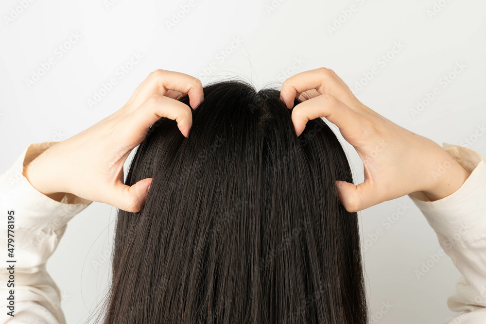 Woman scratching her head because of an itchy scalp. Causes of itchy ...