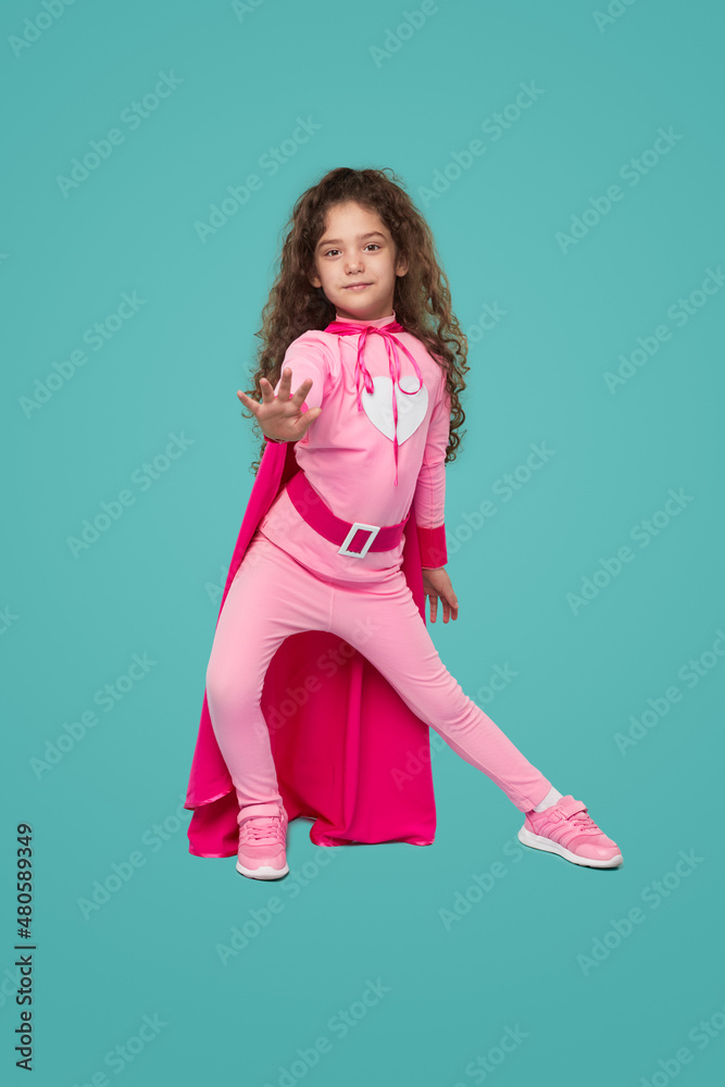 Girl in superhero costume showing superpowers Stock Photo | Adobe Stock