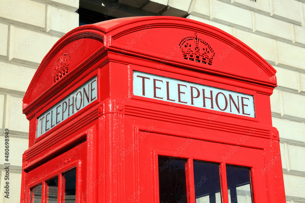 Traditional red cast iron payphone public kiosk telephone box in London ...