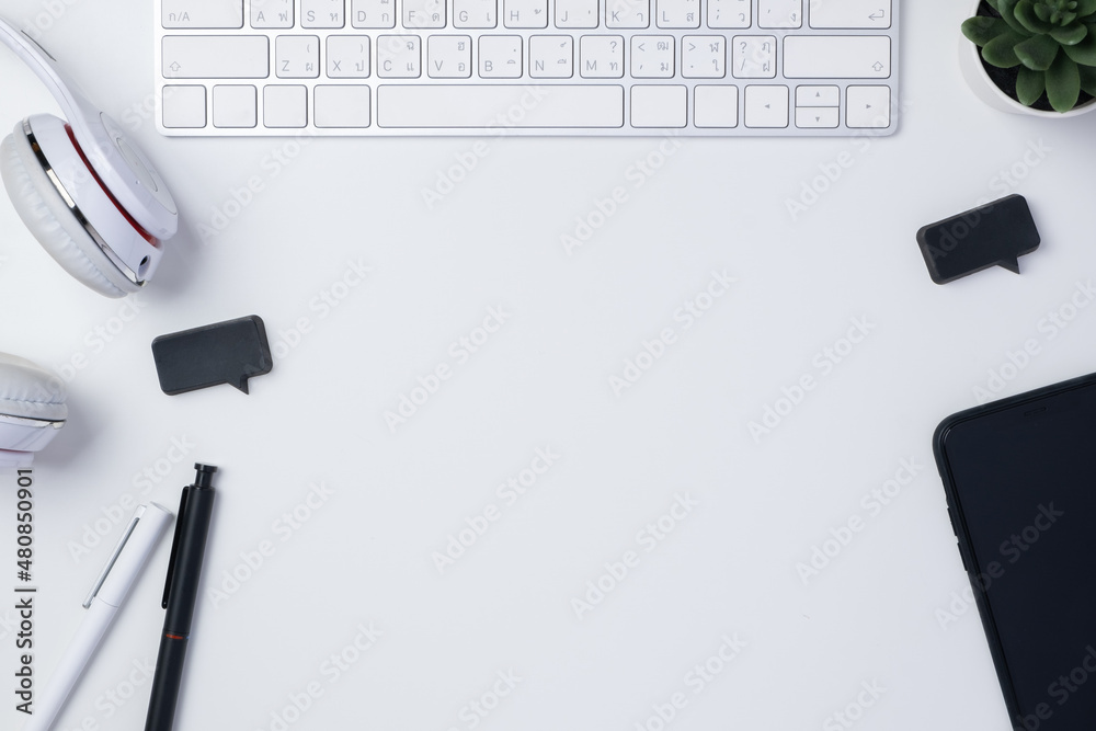 top view working desk with keyboard headphone and mobile phone on white ...