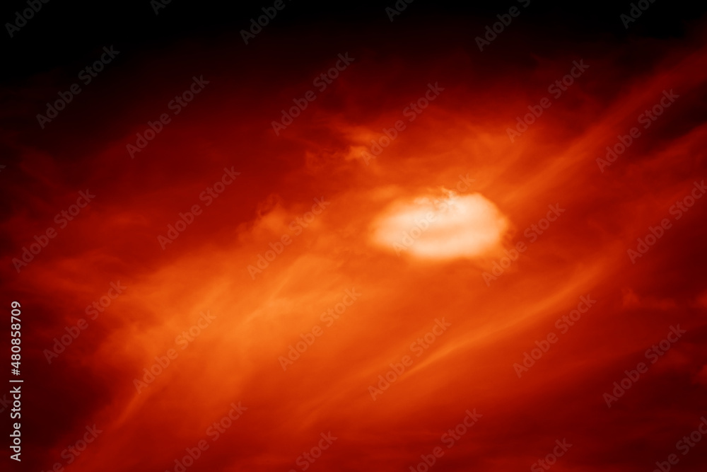 Red orange dramatic fiery sky with black clouds and yellow sunlight at ...