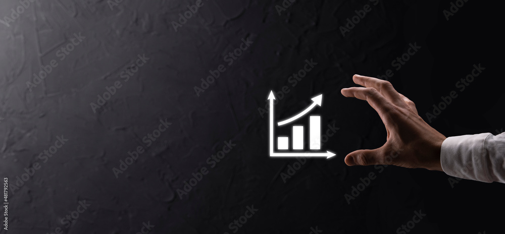 Businessman man holding a graph with positive profits growth. plan ...