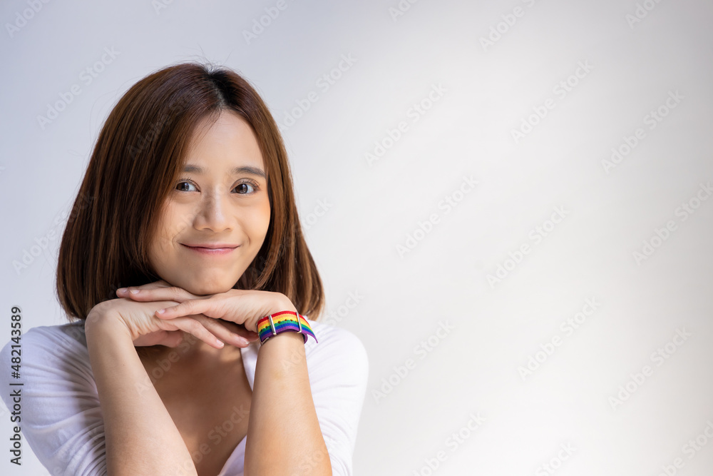 Happy asian LGBT woman wearing LGBTQ rainbow wristband, concept of gay ...