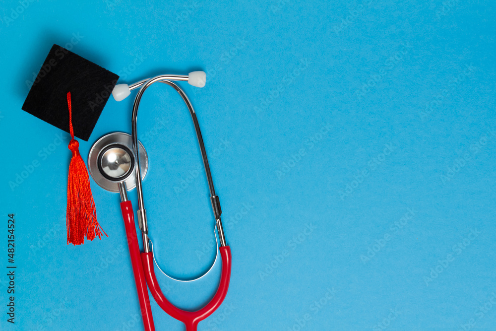 graduation medical concetp. Graduation cap and stethoscope on blue ...